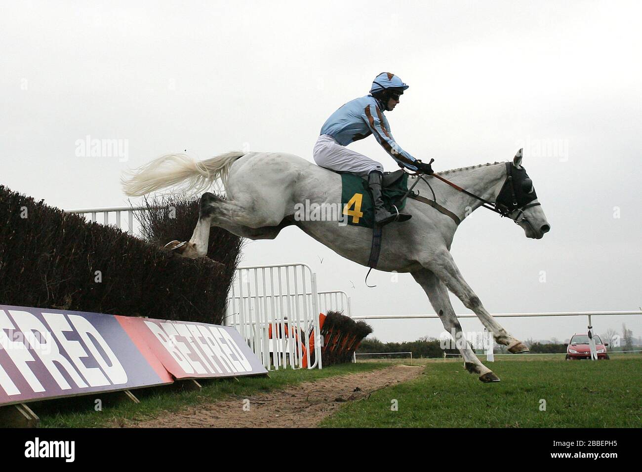 Racer winner Silver Adonis ridden by Mr T Weston jumps during the Tim ...