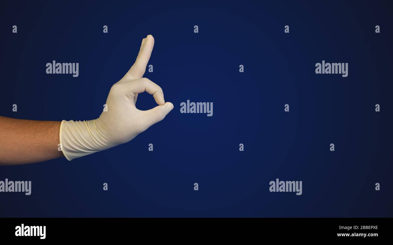 Medical Professional with glove hand showing hope gesture Stock Photo ...