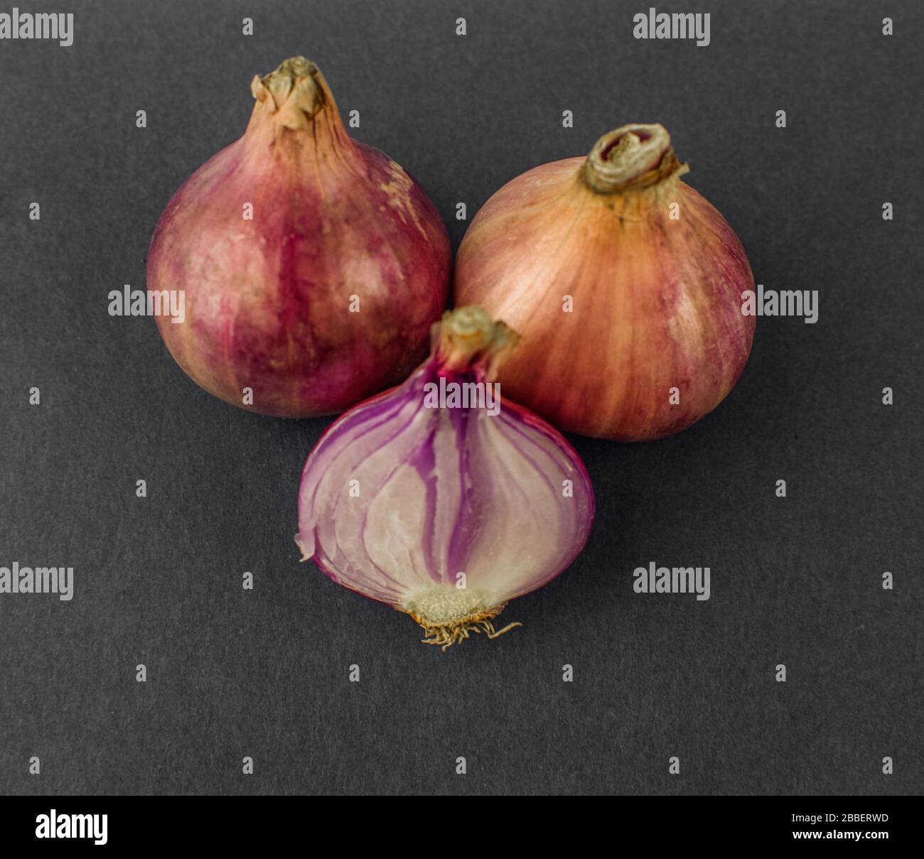 Two and a half medium size fresh and ripe red onion isolated on an ...