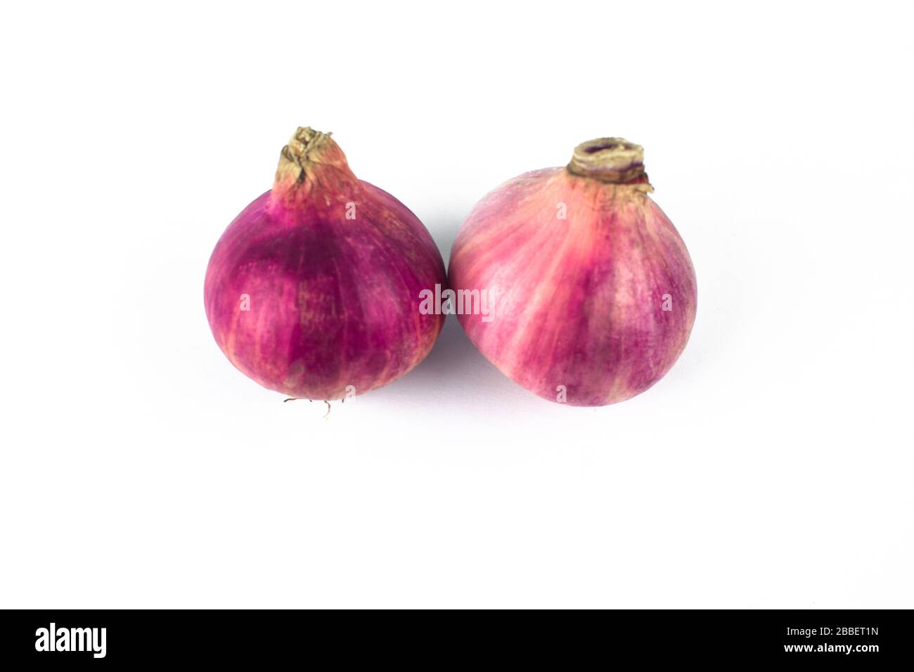 Two medium size fresh and ripe red onion isolated on a bright white ...