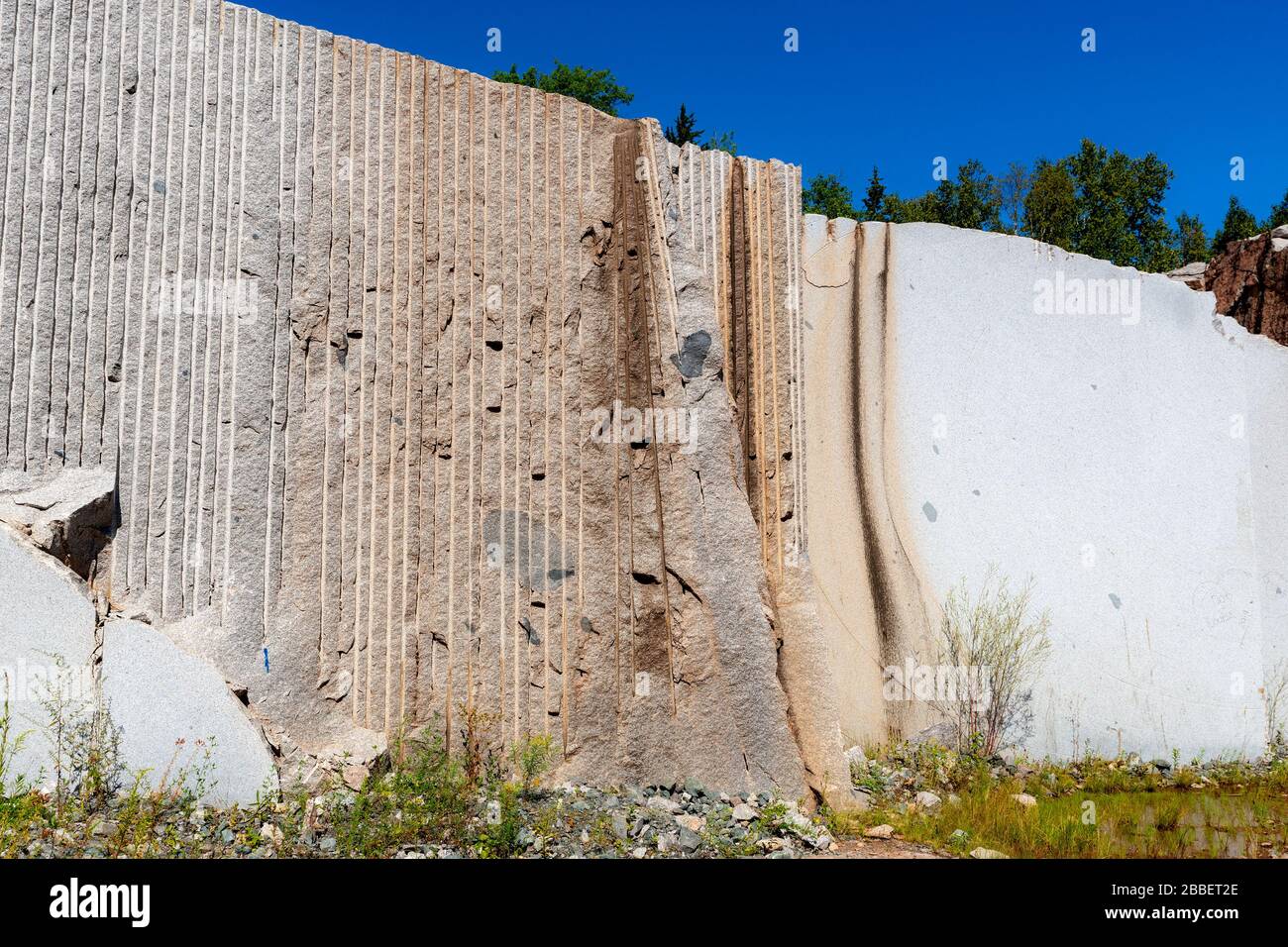 A series of vertical lines and smooth polished rock in a cliff face in ...