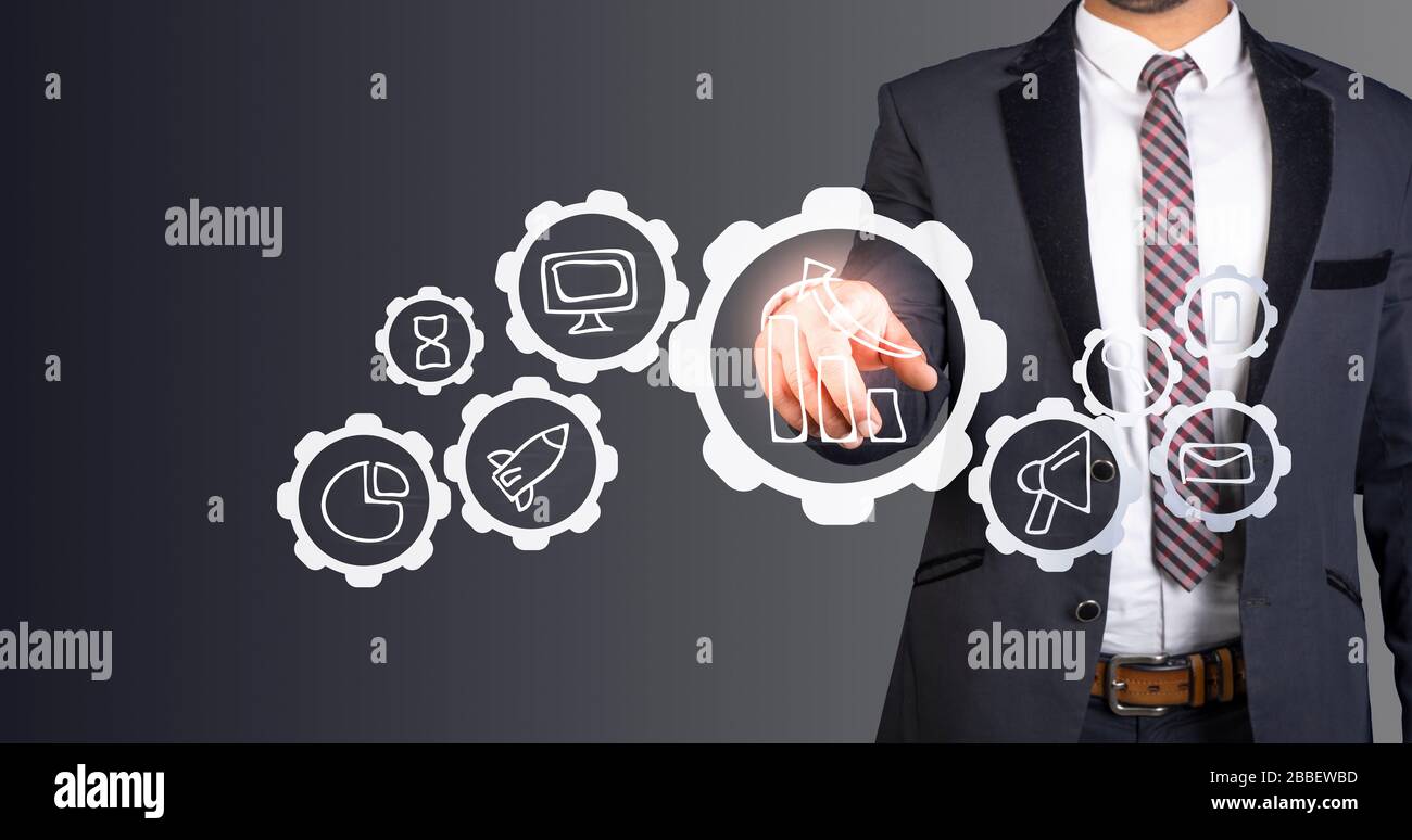 Businessman pushing on marketing icons with working in office ...
