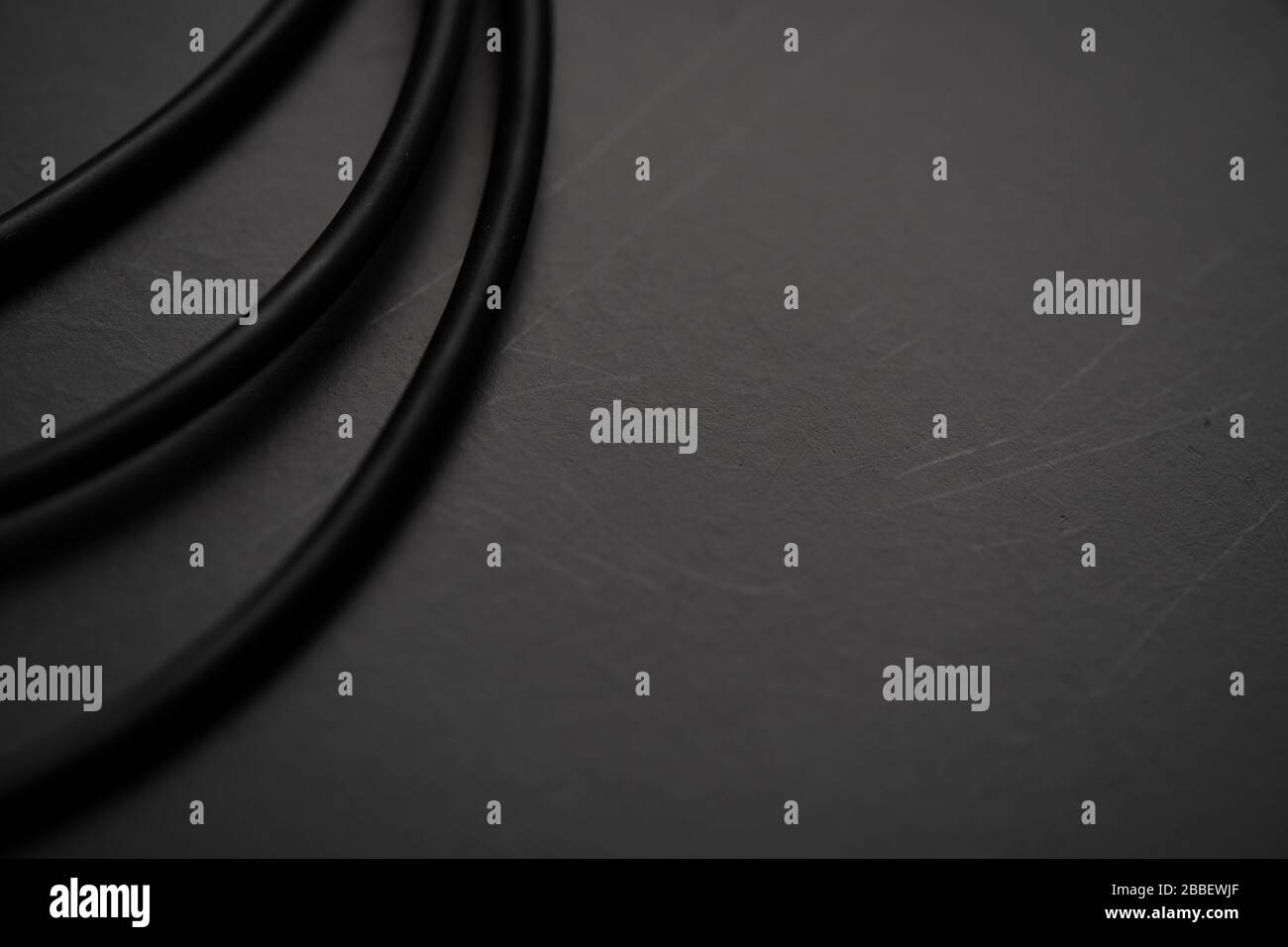 Black wire on black background Stock Photo - Alamy