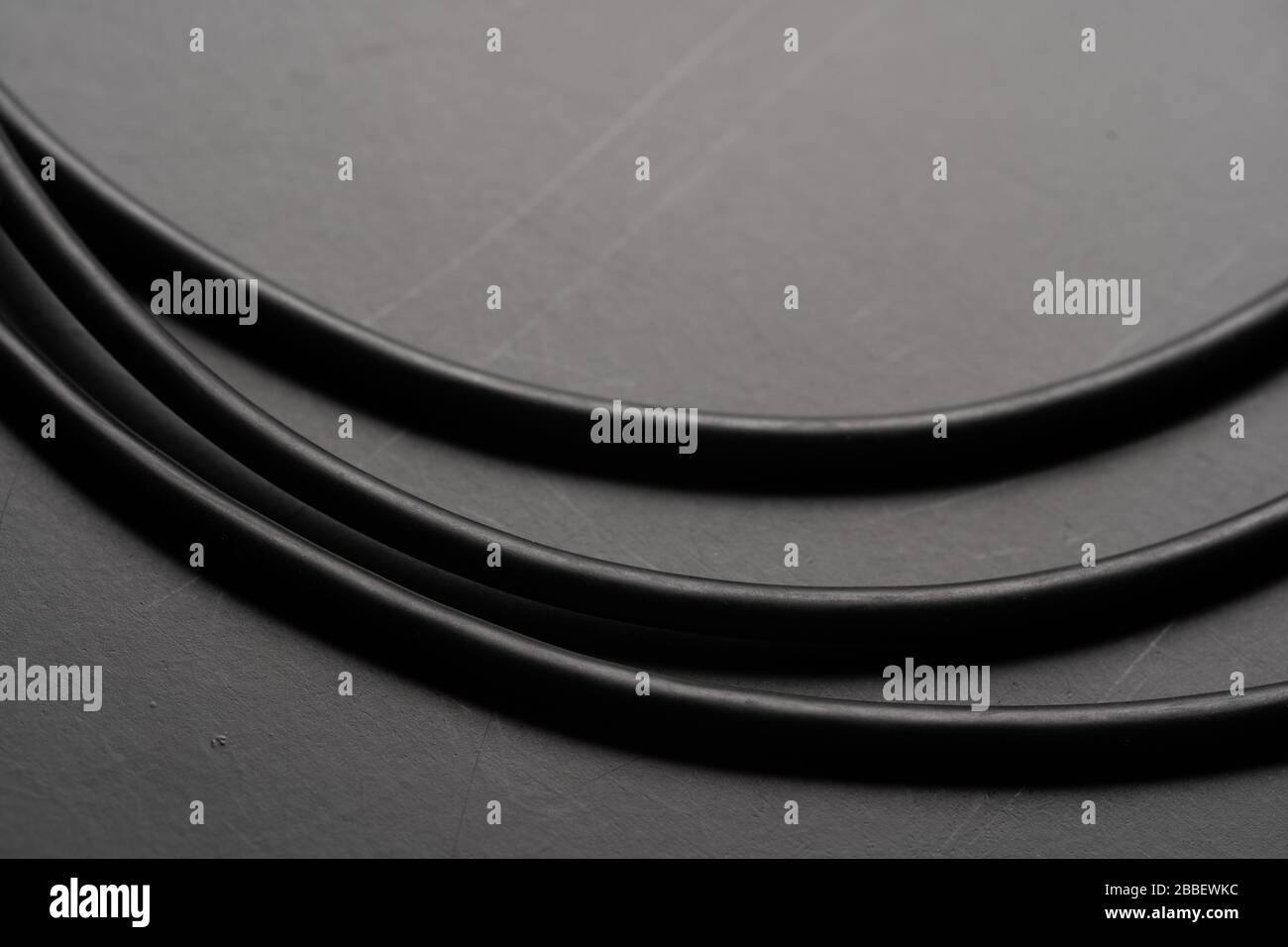 Black wire on black background Stock Photo - Alamy