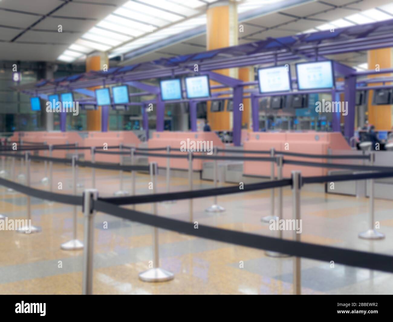 Blurred background of check-in counters at a generic empty airport ...