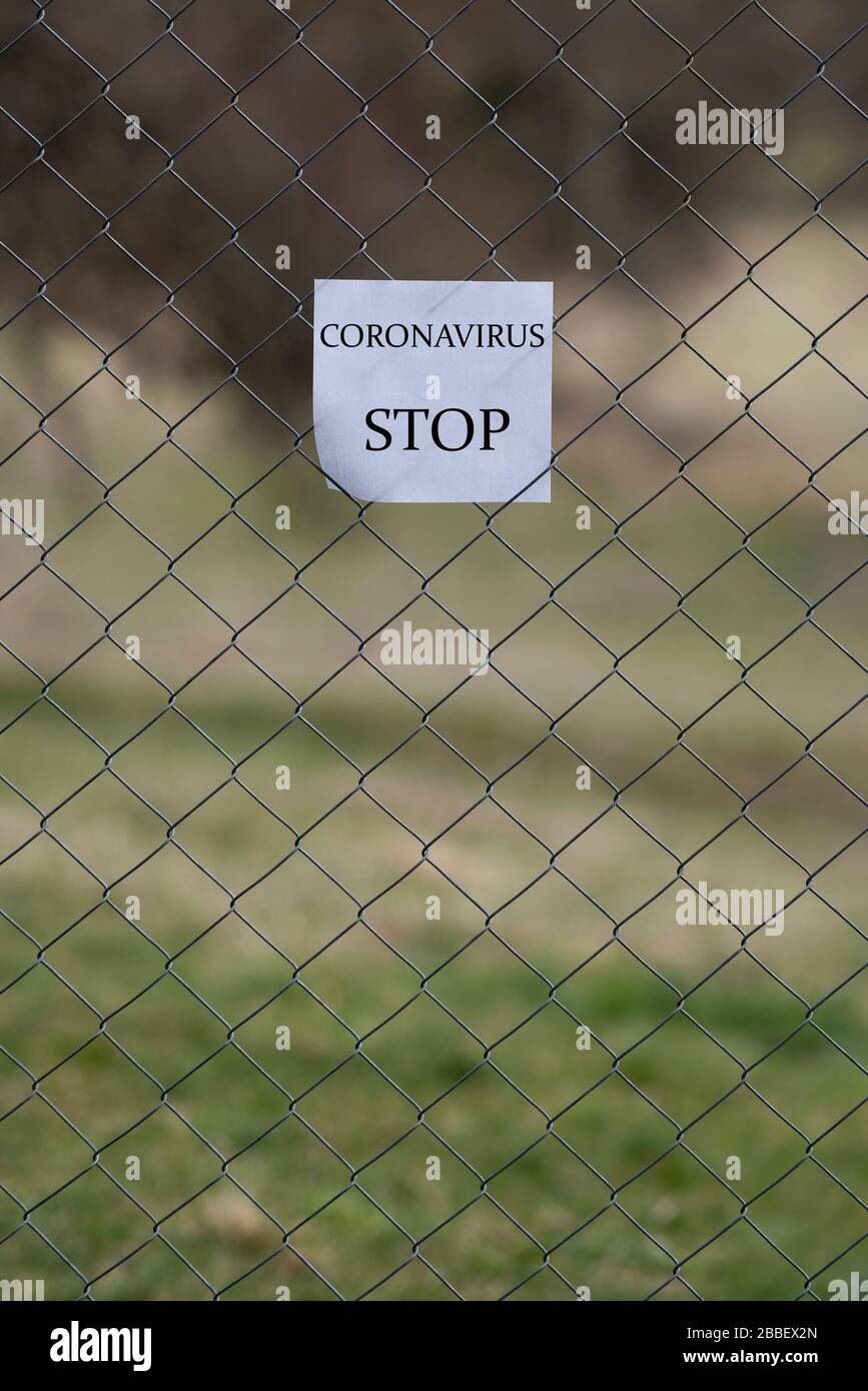 No entry due to coronavirus. Fence with coronavirus inscription and ...