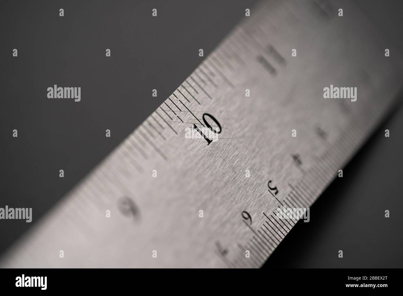 Metal ruler on a black leather isolated background with black numbers ...