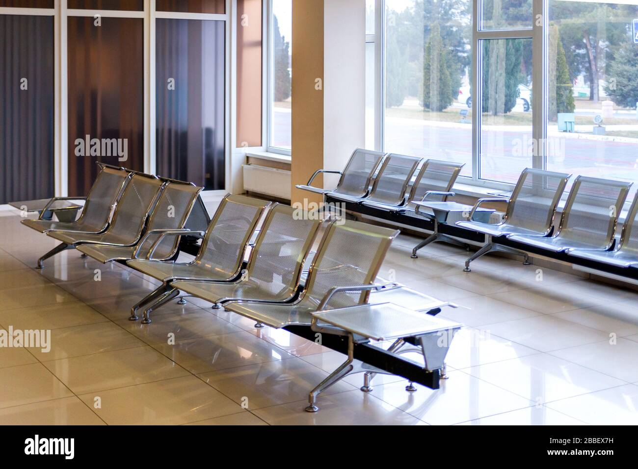 Airport gate waiting area with metal seats Stock Photo - Alamy