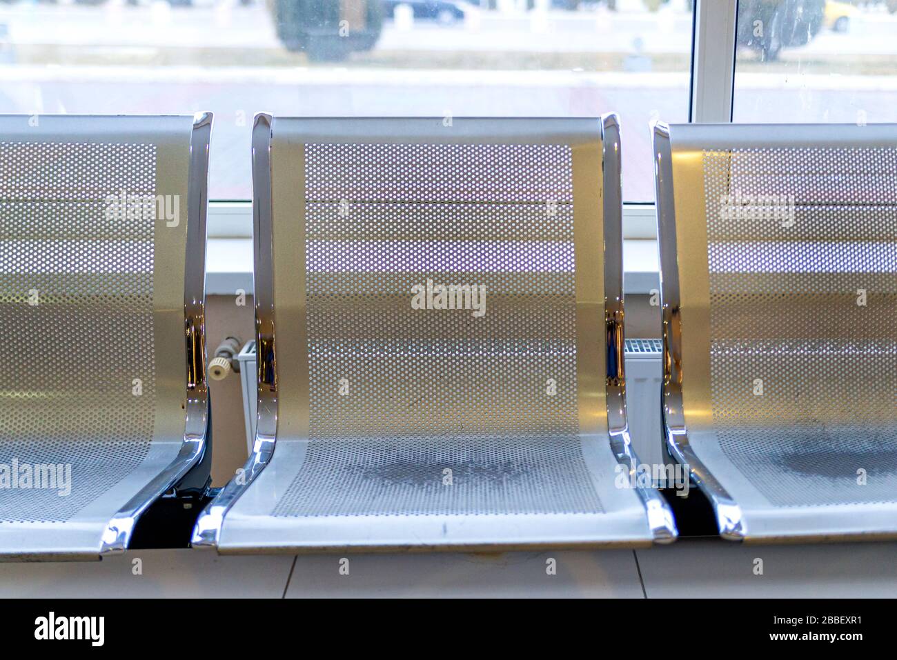 Airport gate waiting area with metal seats Stock Photo - Alamy