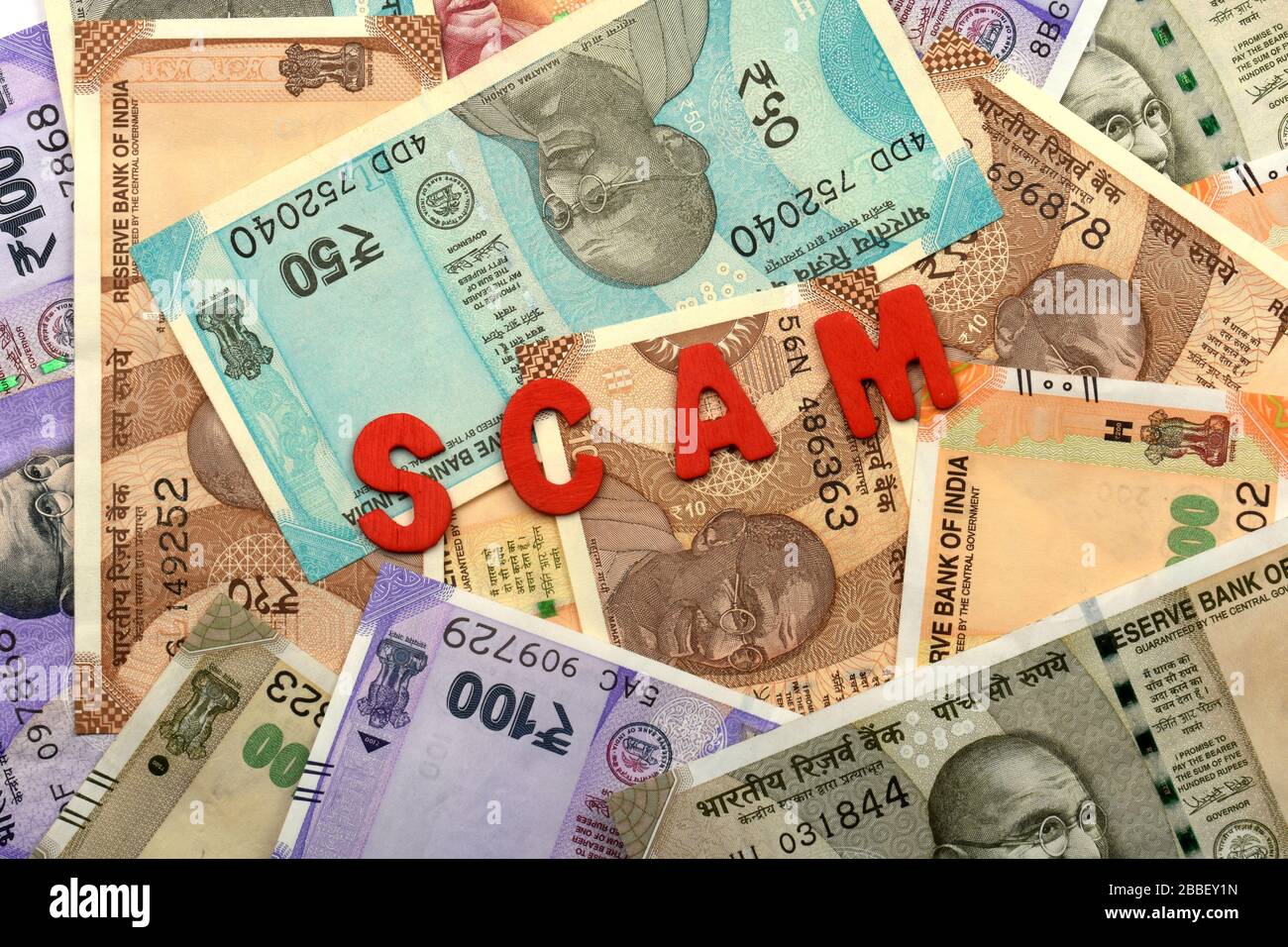 Scam and money concept,Scam red alphabet on money background,Indian ...