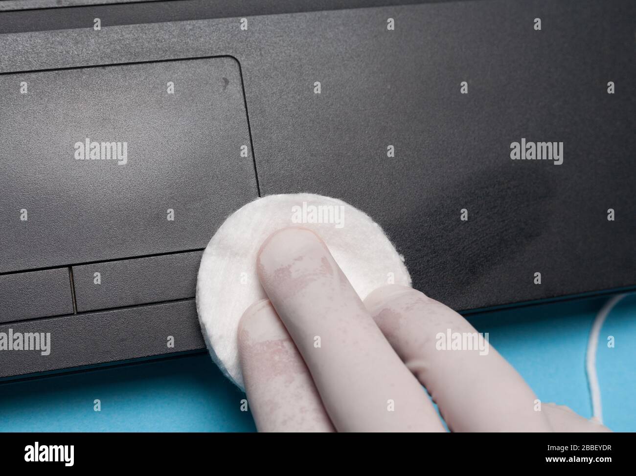 Close-up of disinfection cleaning a laptop in white gloves. Prevention ...