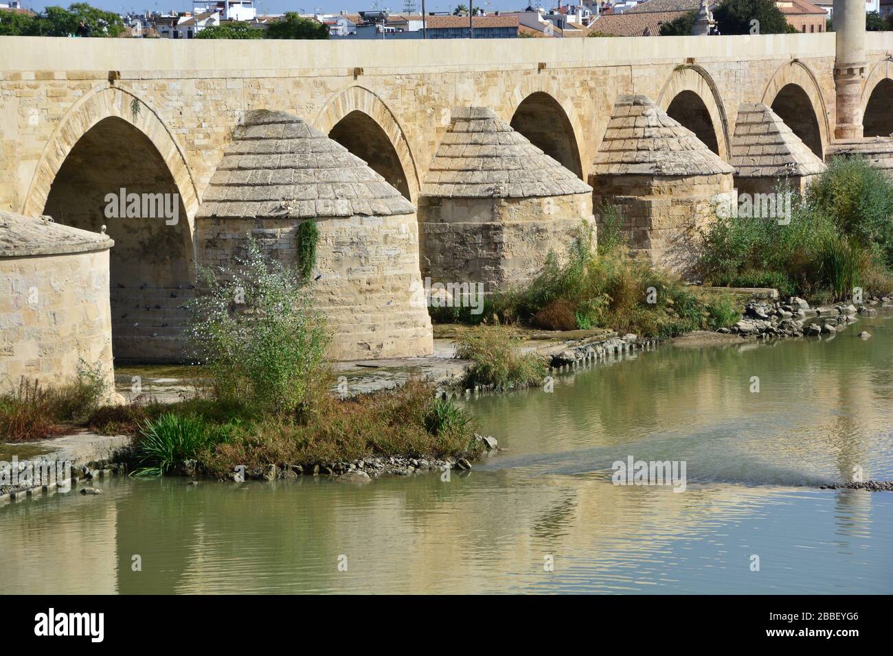 Cordoba, Spain: panoramic view of long, restored bridge with many ...
