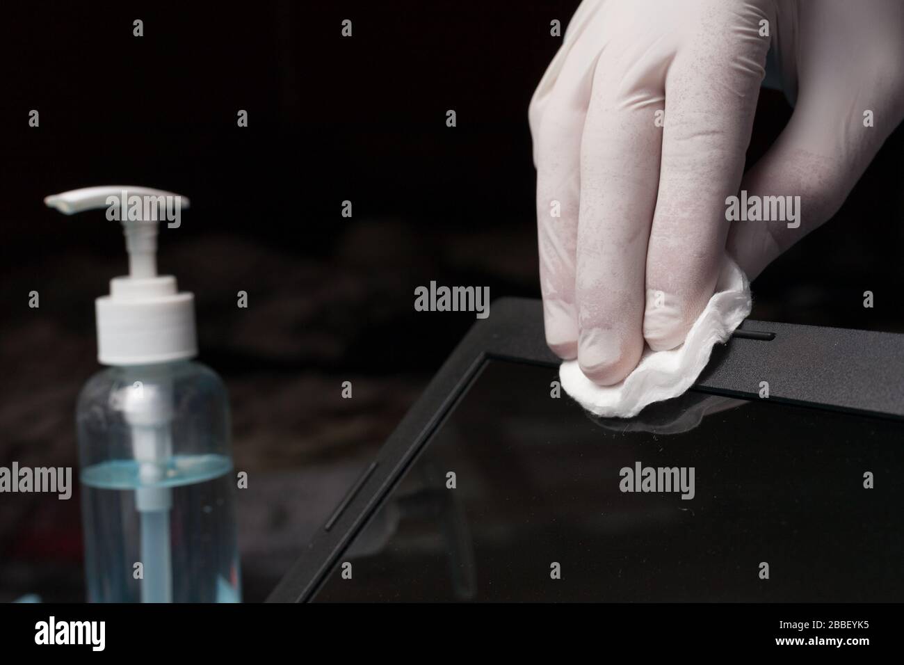 Close-up of disinfection cleaning a laptop in white gloves. Prevention ...