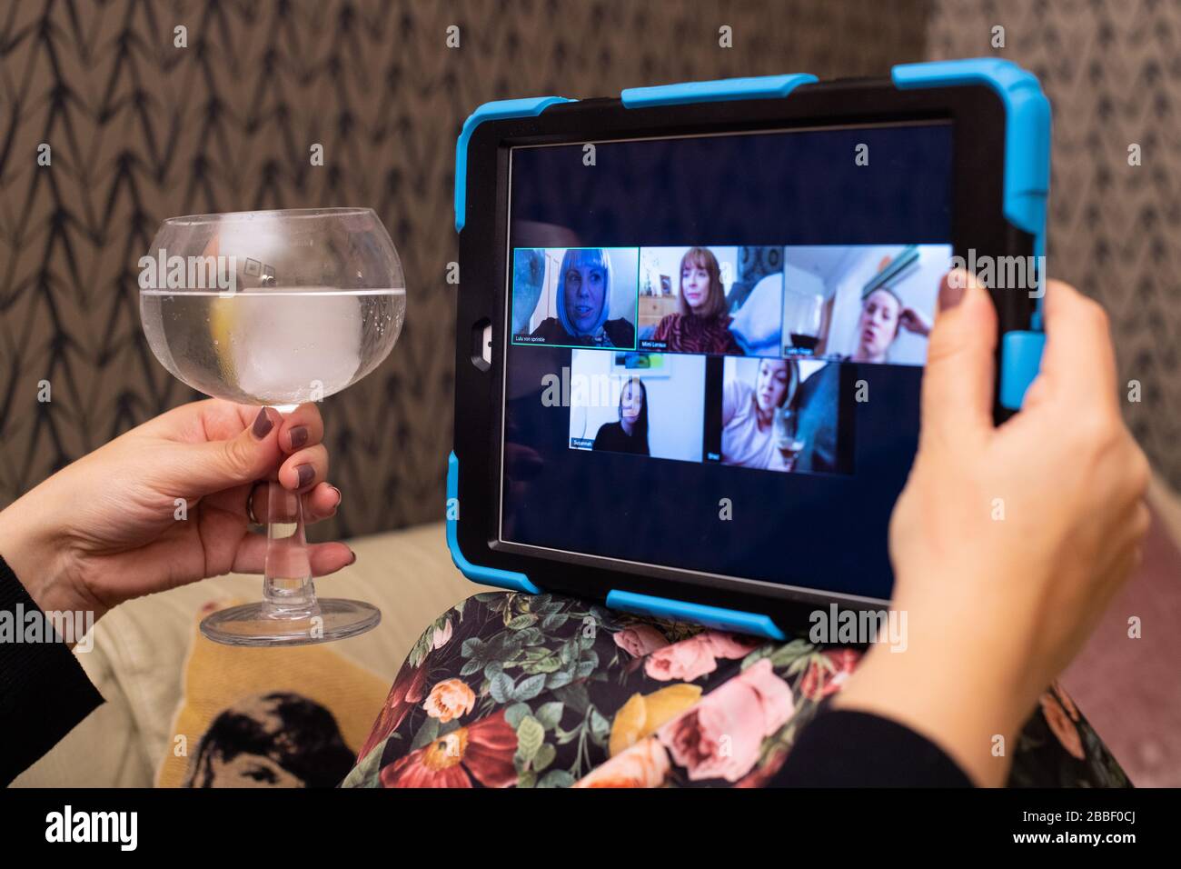 A group of women use the Zoom video conferencing application to have a ...