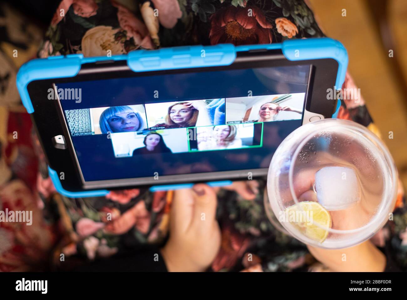 A group of women use the Zoom video conferencing application to have a ...