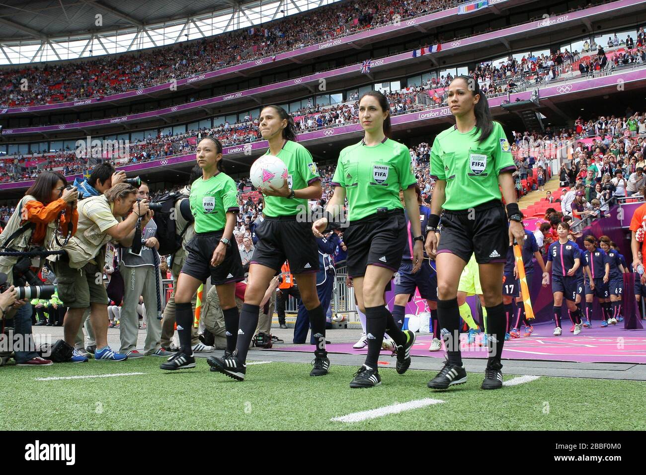 The match official lead the teams out Stock Photo - Alamy