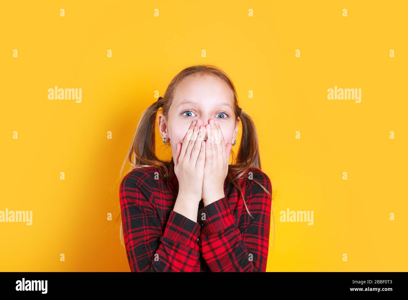 Photo of shocked little girl child over yellow background Stock Photo ...
