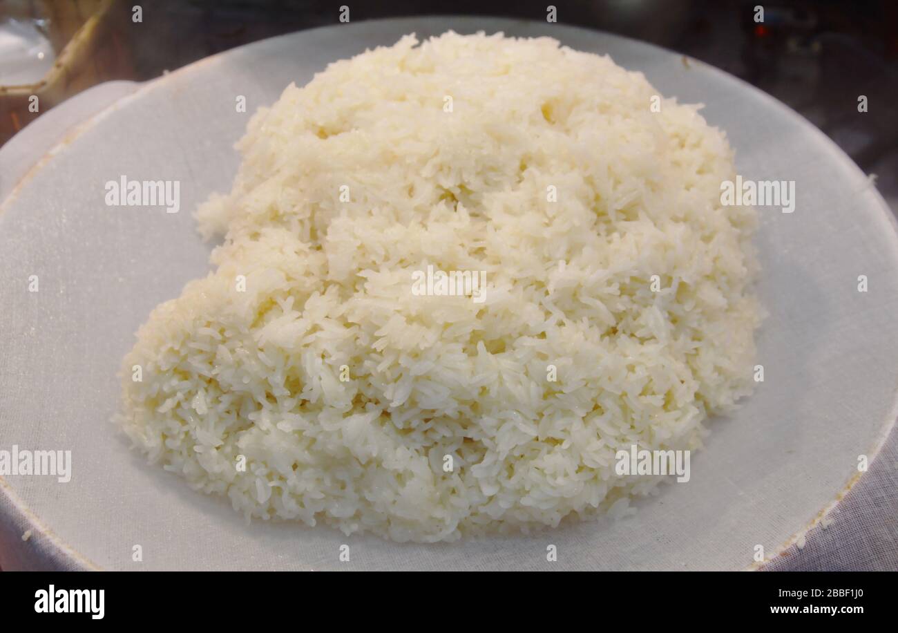 sticky rice cooking on white straining cloth Stock Photo - Alamy