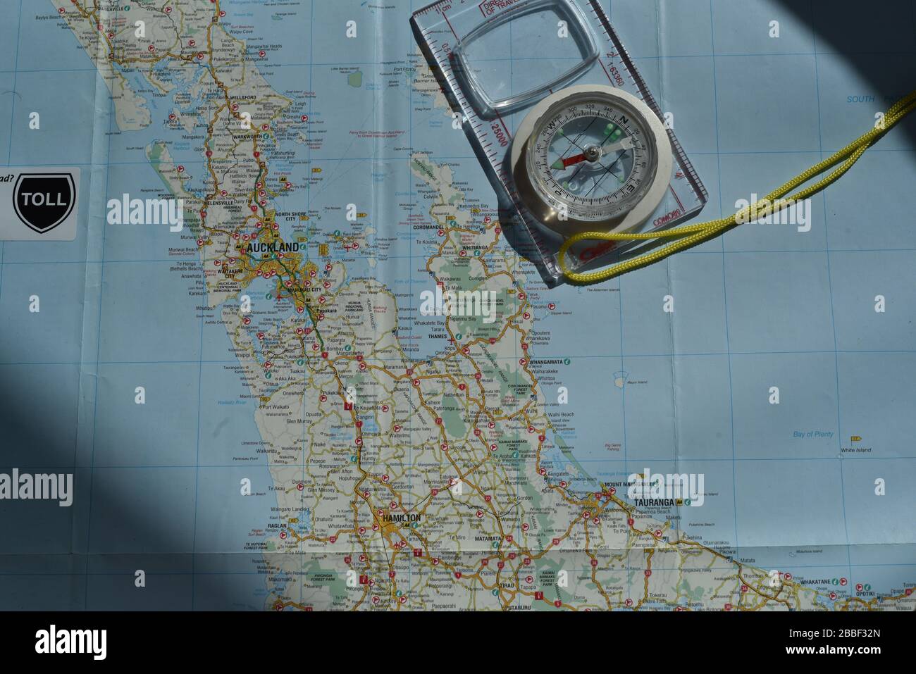 Map reading on a new zealand map with compass Stock Photo - Alamy