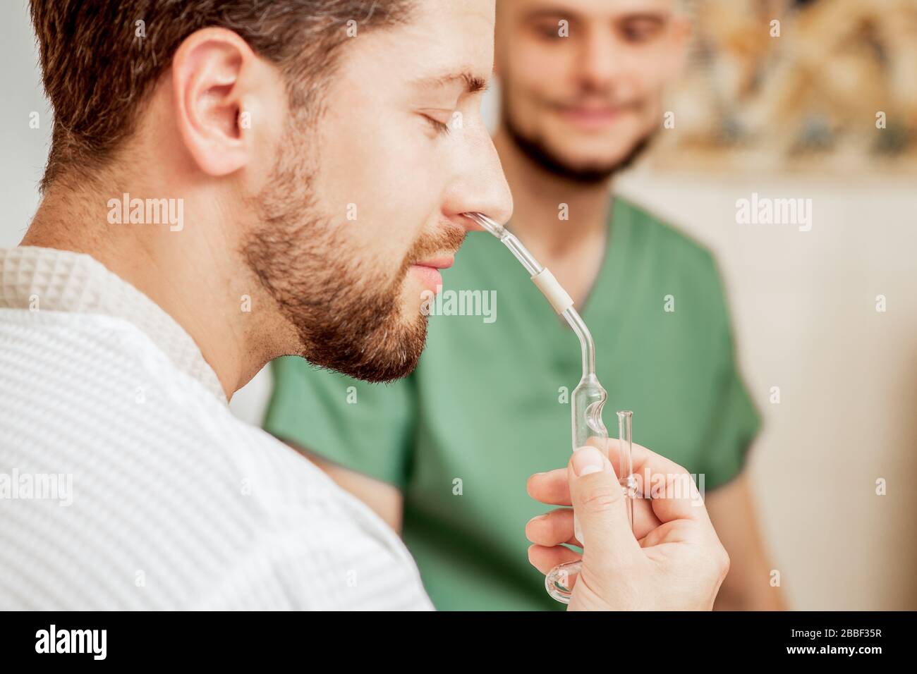 Man receives nasal inhalation Maholda by essential oil in nose at spa ...