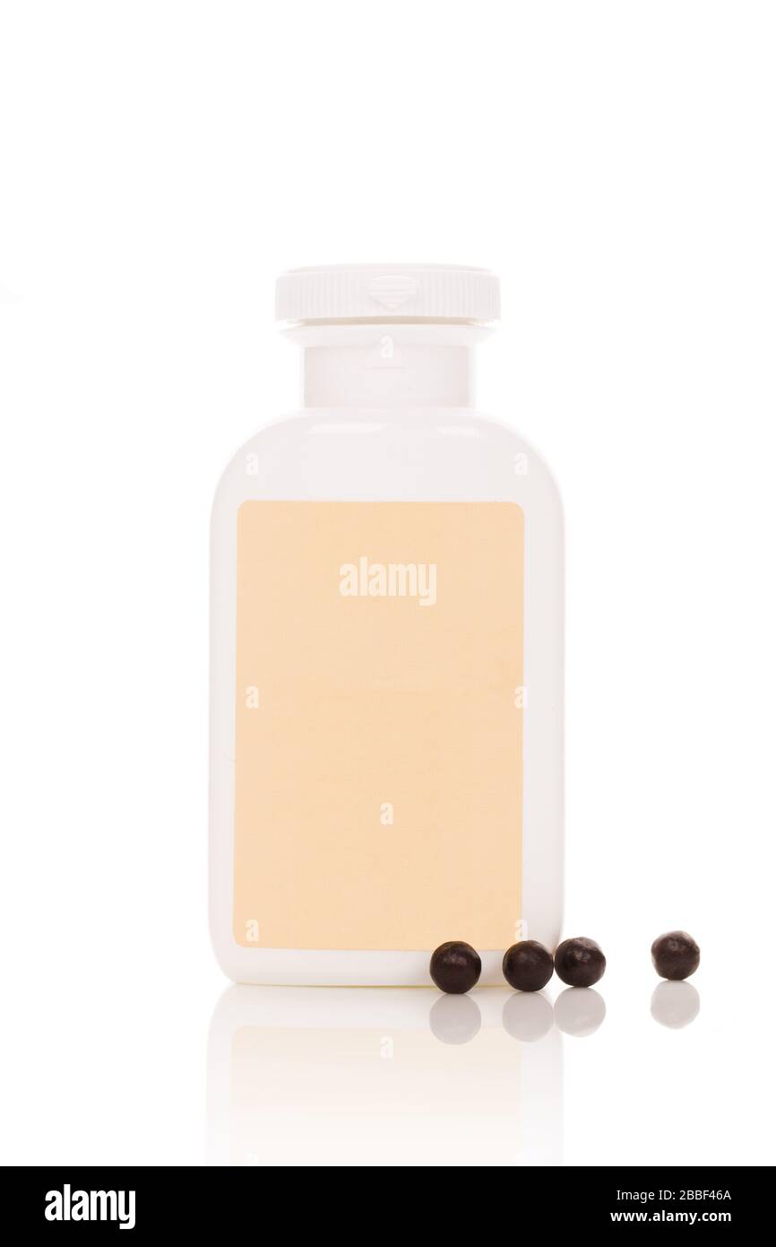 Chinese herbal patent medicine in bottle and pills isolated on white ...
