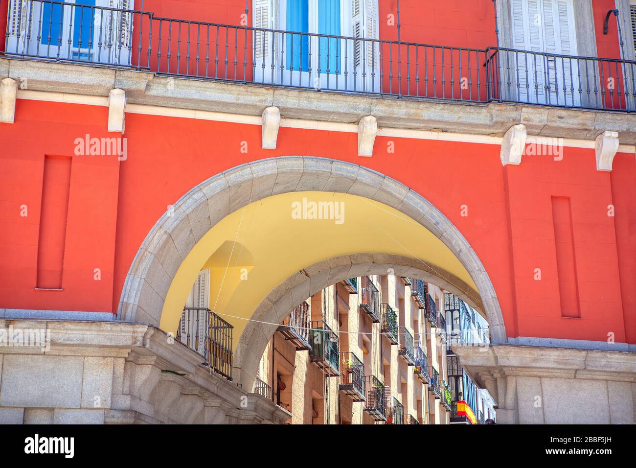 spanish architecture with red wall and arch Stock Photo - Alamy