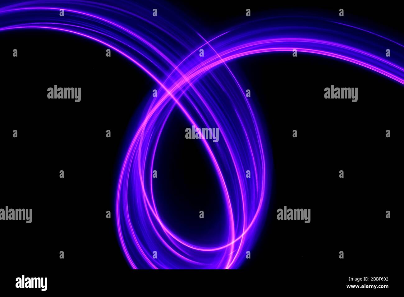 Long exposure photograph of vibrant neon color in an abstract swirl ...