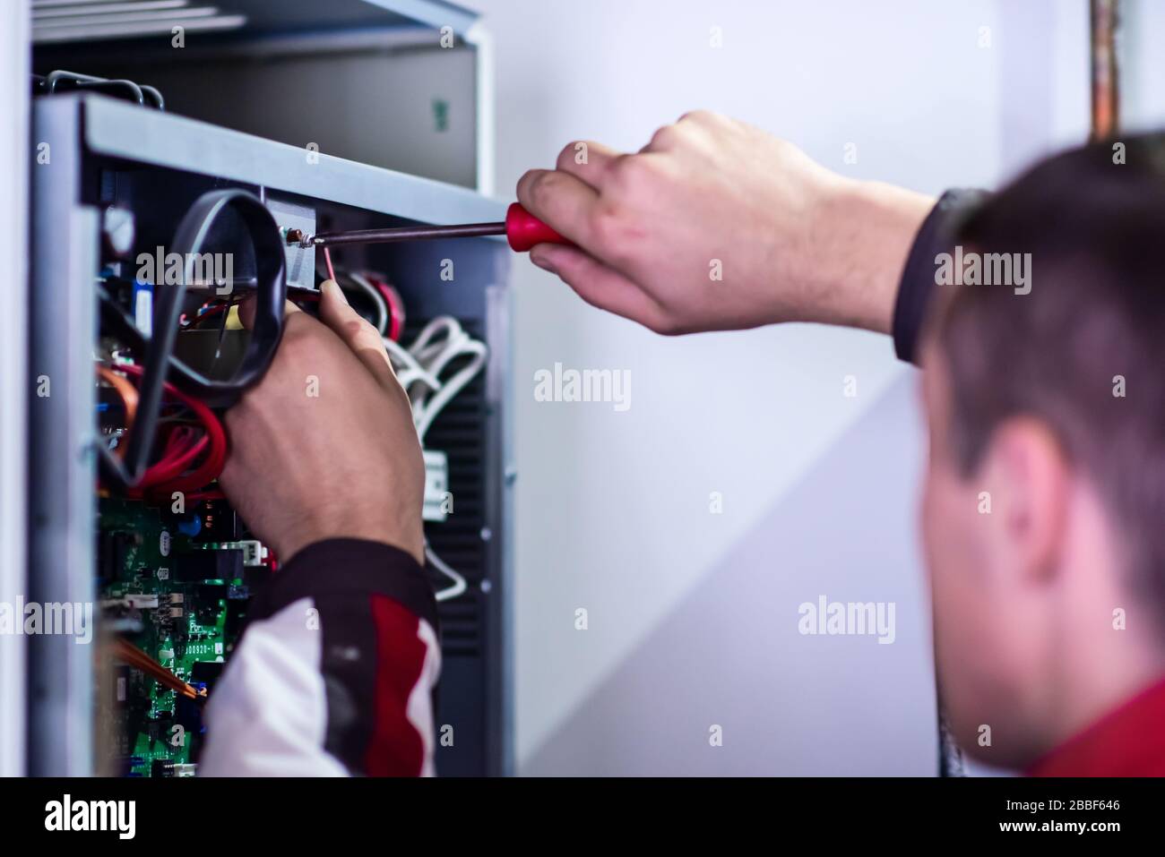 Closeup of electrician engineer working with electric cable wires of ...