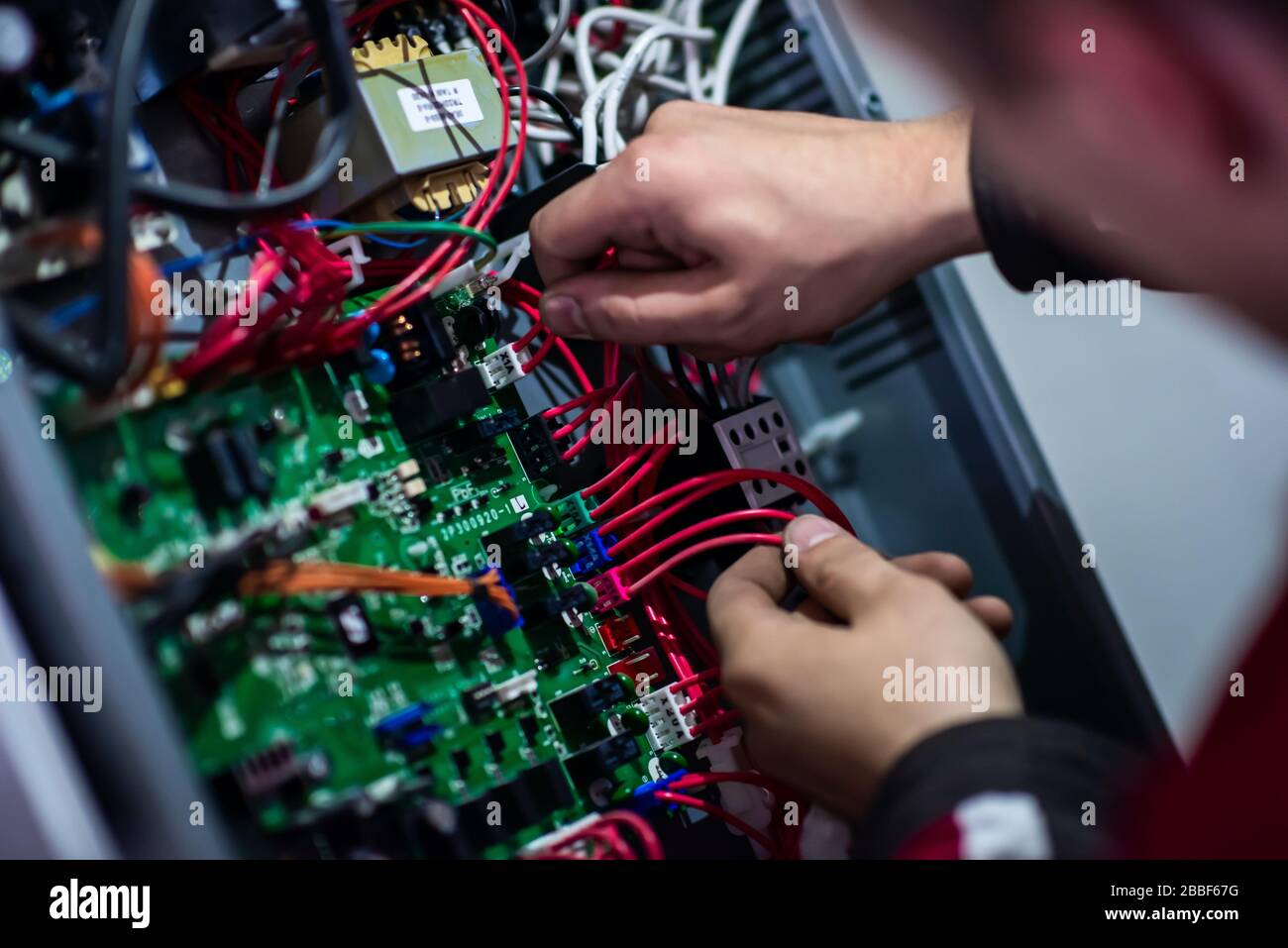Closeup of electrician engineer working with electric cable wires of ...
