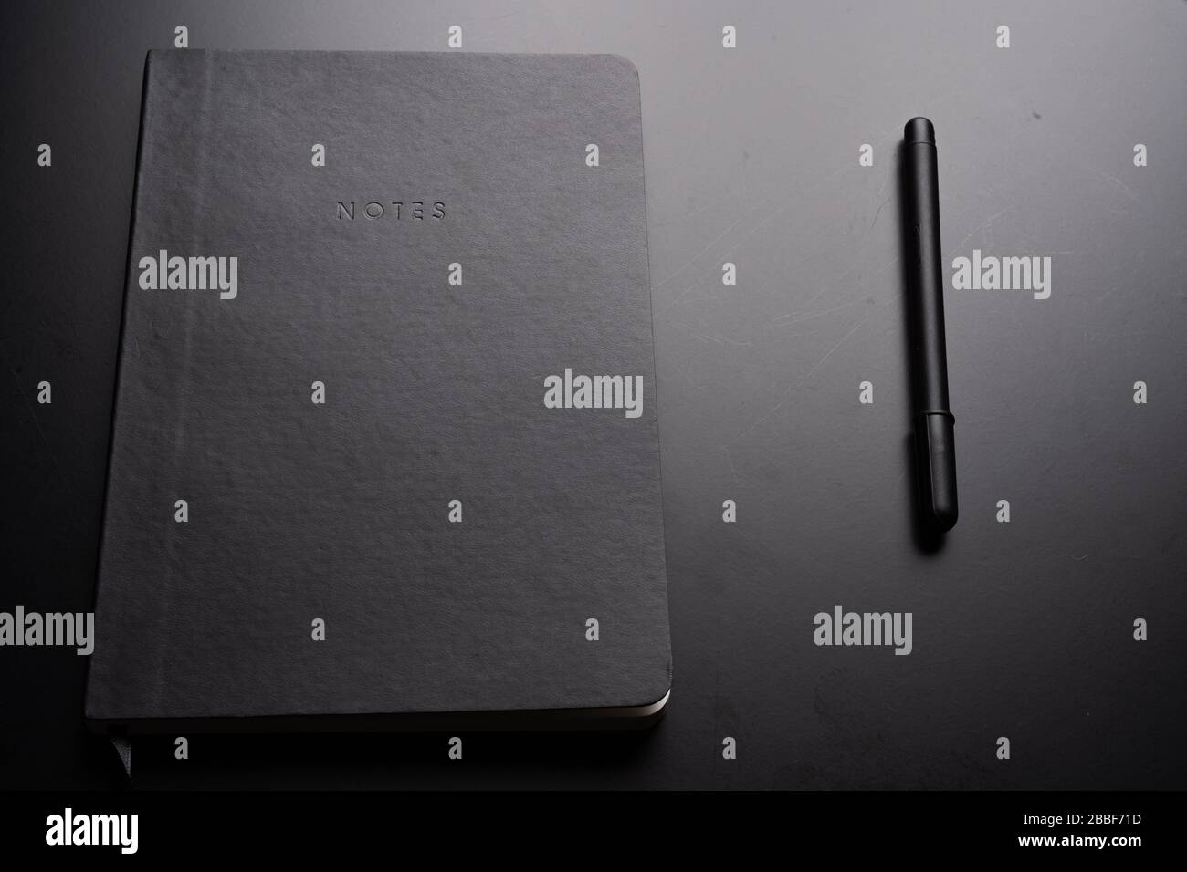 Black style set: notepad and pen on Black background Stock Photo - Alamy