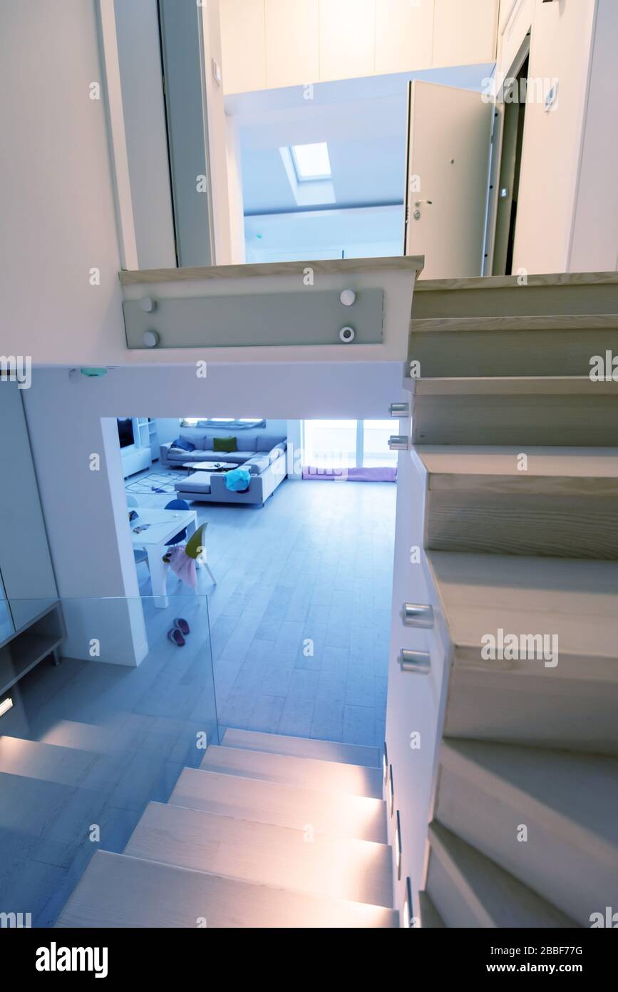 stylish interior with wooden stairs in big modern two level luxury ...