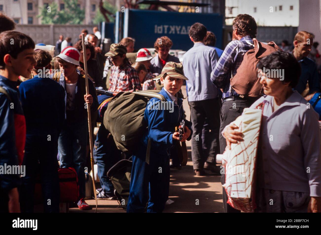 A young cadet points a toy rifle at the camera, Moscow railway station ...