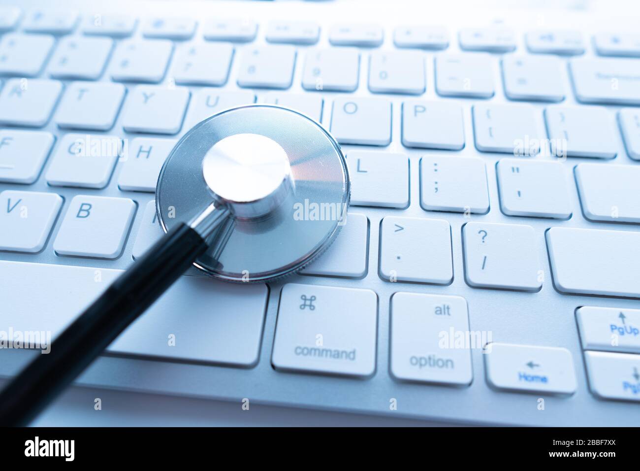 Macro view of a stethoscope on computer keyboard and key button with ...