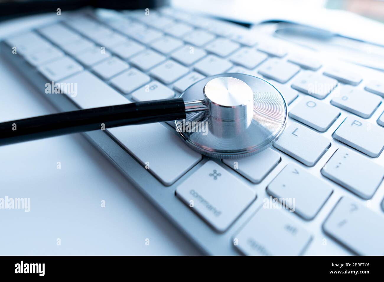 Macro view of a stethoscope on computer keyboard and key button with ...