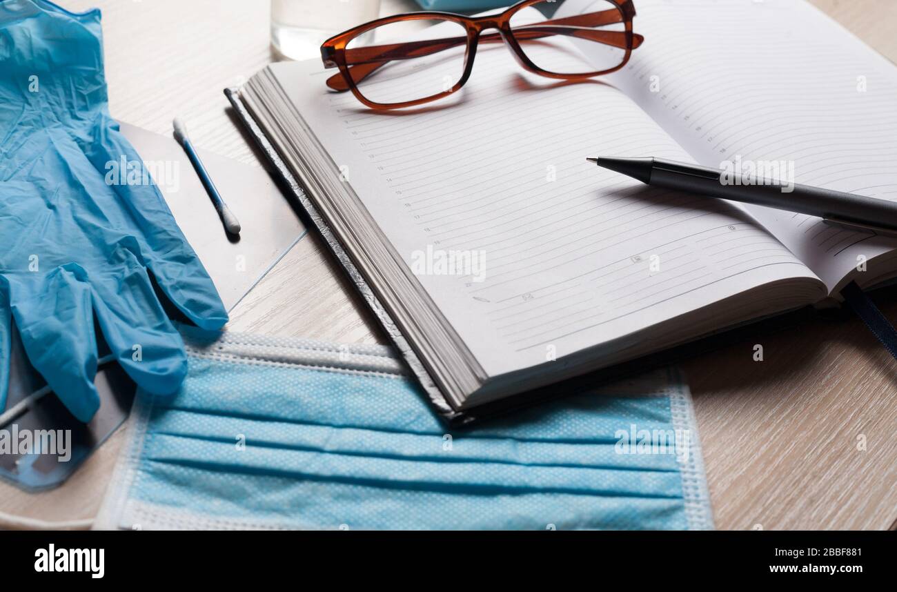 Empty notepad on hospital desk surrounded by medical equipment. Top ...