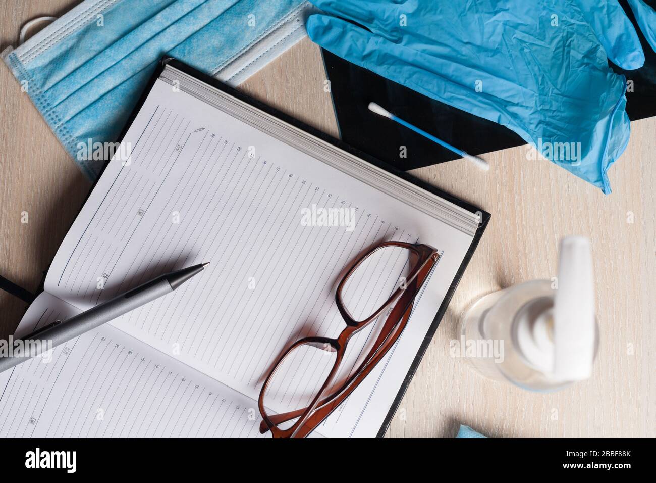 Empty notepad on hospital desk surrounded by medical equipment. Top ...
