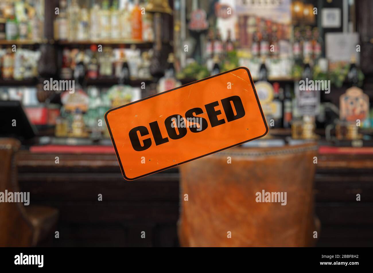 Empty pub, closed sign, focus on foreground with blurred background ...