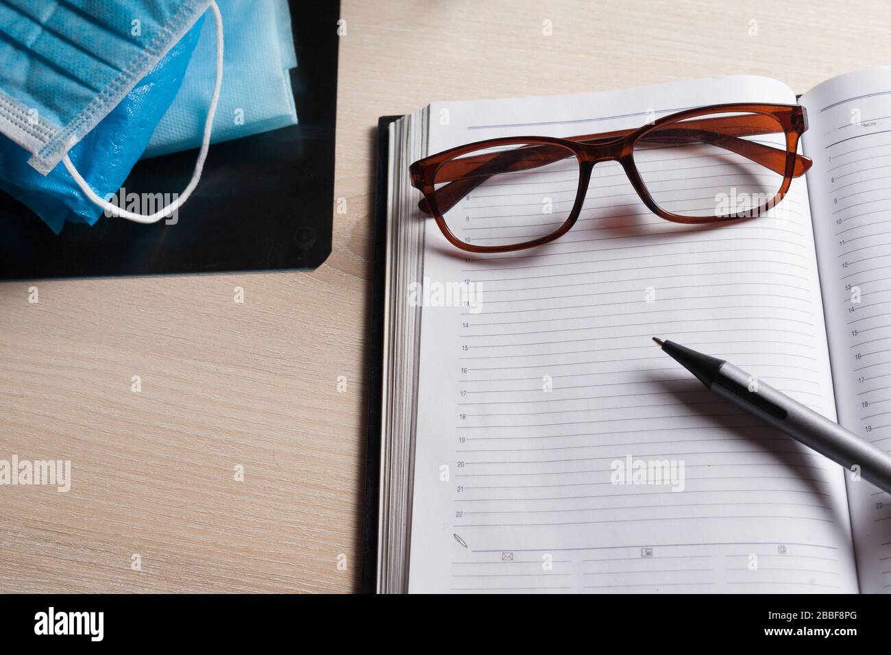 Empty notepad on hospital desk surrounded by medical equipment. Top ...