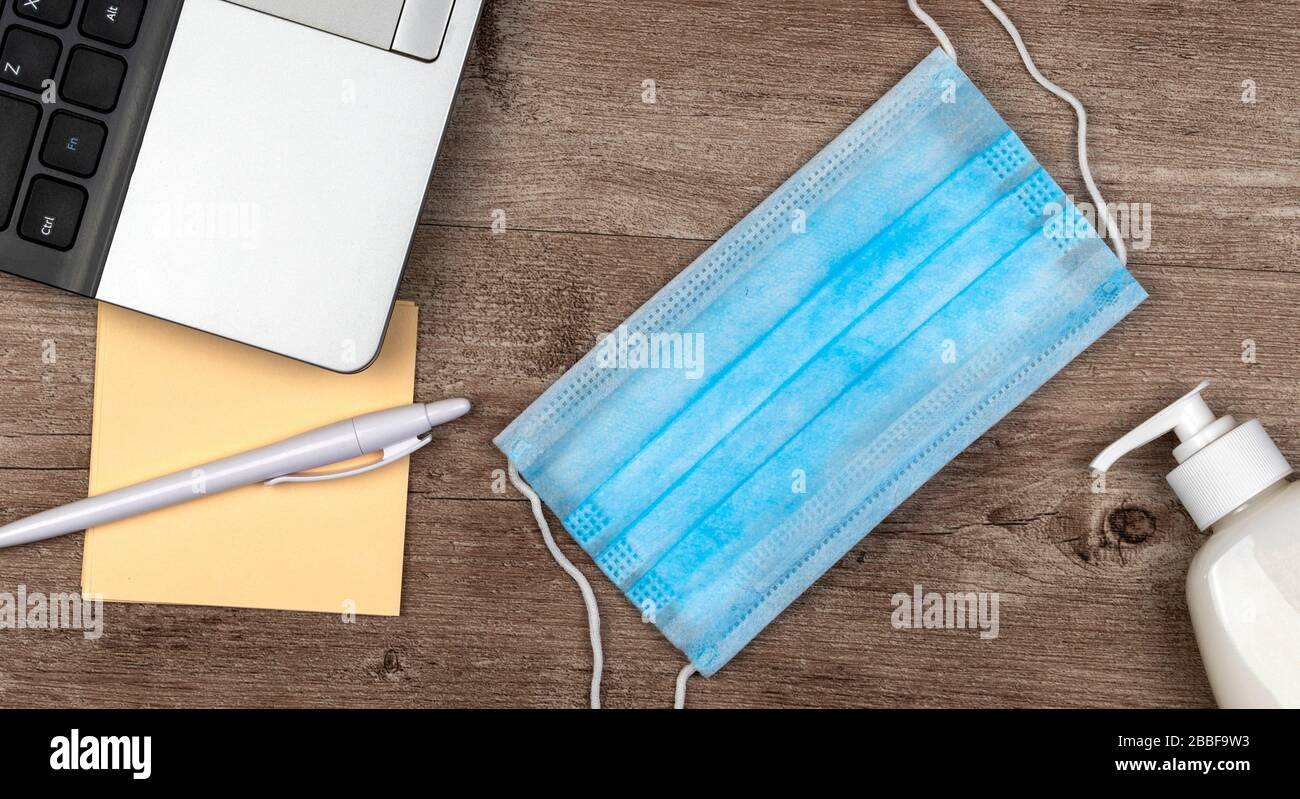 hygiene in the office. remote work kit on wooden desk. sanitizer gel ...