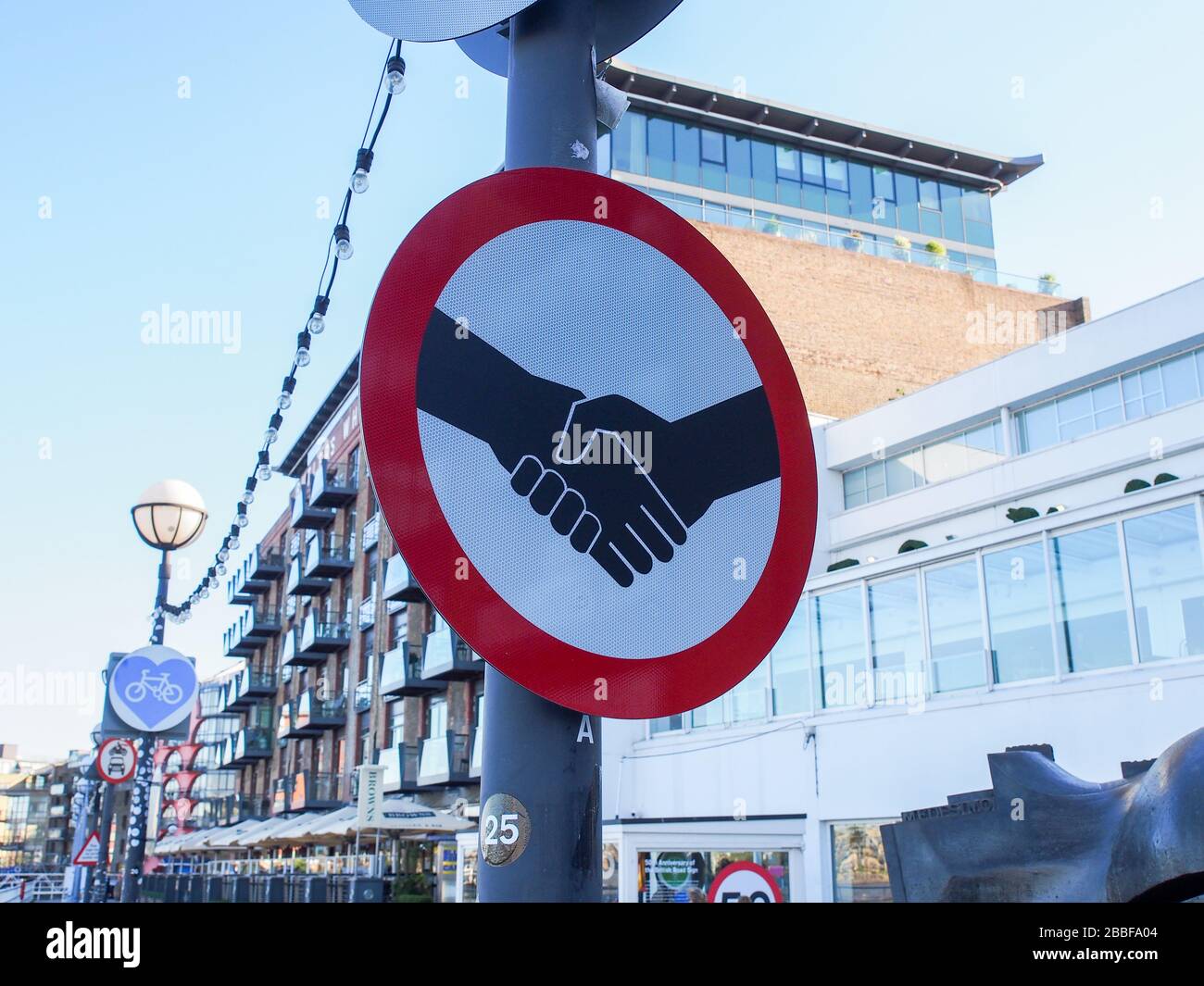 Hand shake red sign - London Stock Photo - Alamy