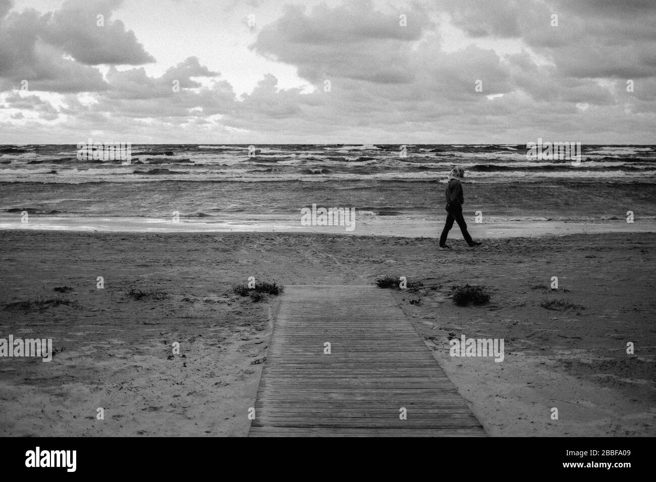 Lonely walk on the beach Stock Photo - Alamy