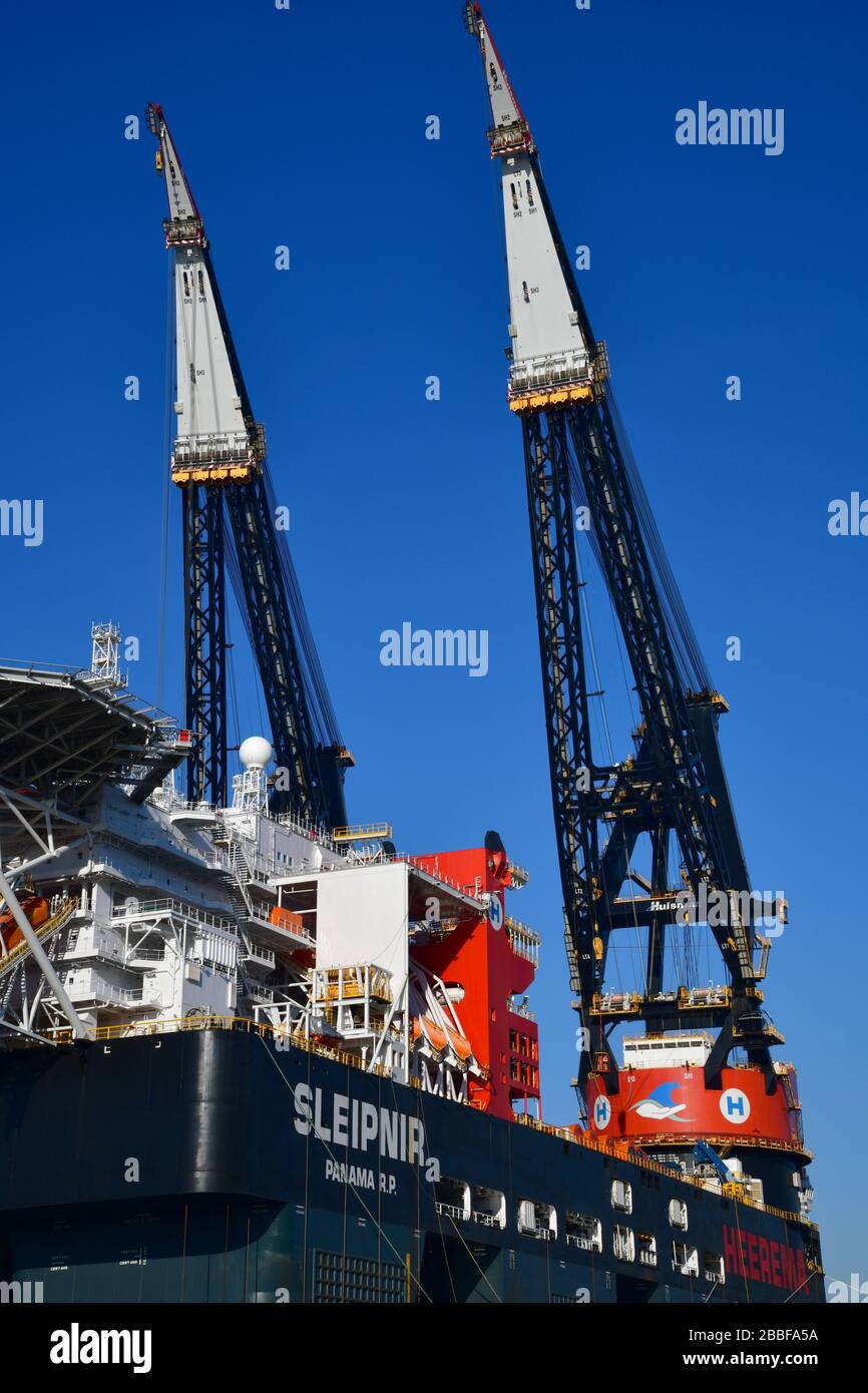 Rotterdam, The Netherlands-March 2020: Low angle view of two large cranes on offshore platform ...