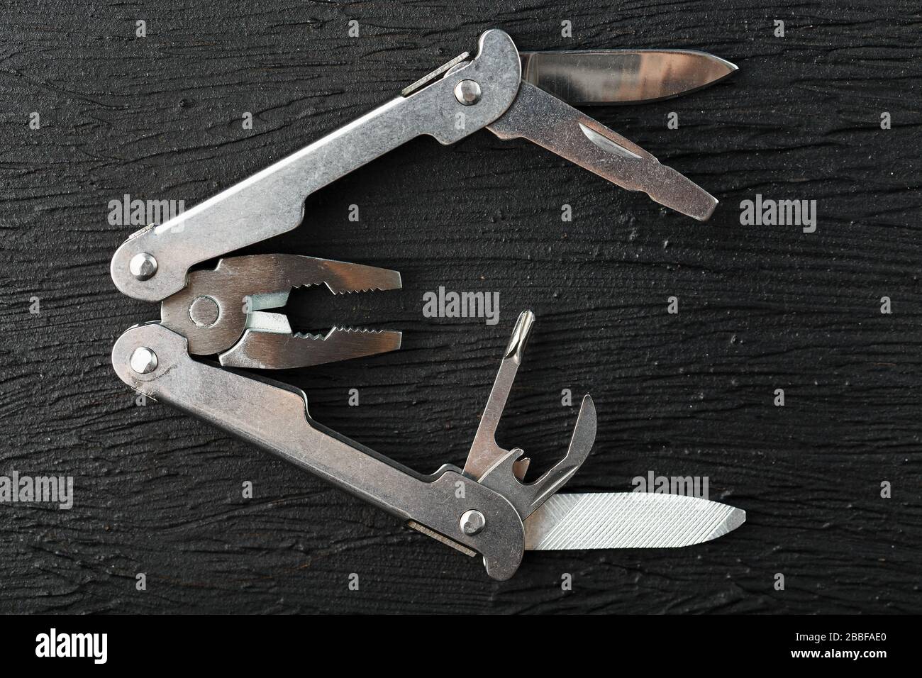 Multitool is a multi-functional tool on a black background. The concept ...