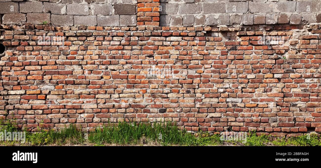 The dilapidated old brick wall made of red brick Stock Photo - Alamy