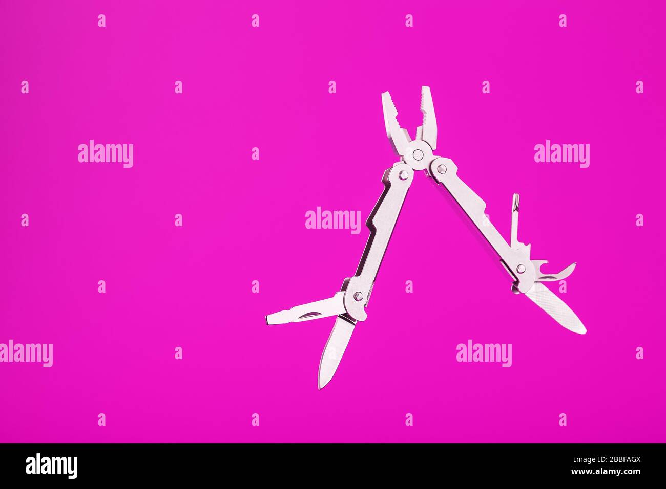 Multitool is a multi-functional tool on a pink background. The concept ...