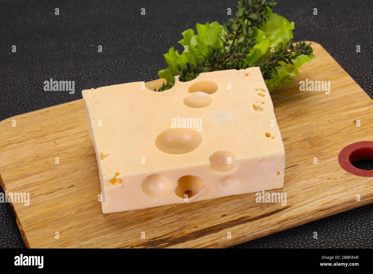 Maasdam cheese brick with thyme branch Stock Photo - Alamy