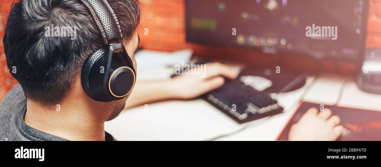 young man playing game on computer, banner Stock Photo - Alamy