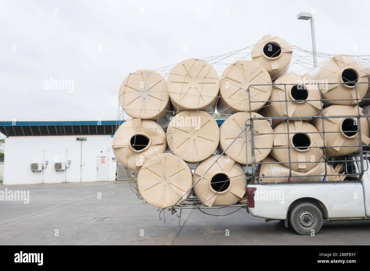 A truck heavy carry big plastic water tank in Thailand Stock Photo - Alamy