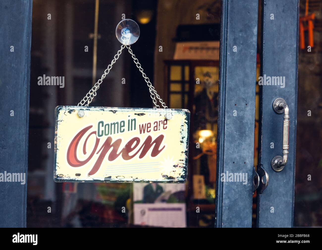 Signboard " We are Open " at in front of shop or restaurant or coffee ...