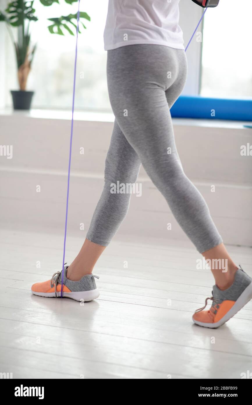 Female patient legs walking with jump rope Stock Photo - Alamy